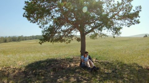Girl Sitting Under Tree Resting Shade Stock Footage Video (100% Royalty ...