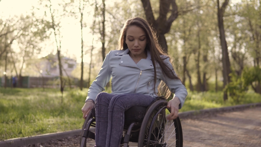 young pretty disabled woman wheelchair walking Stock Footage Video (100 ...