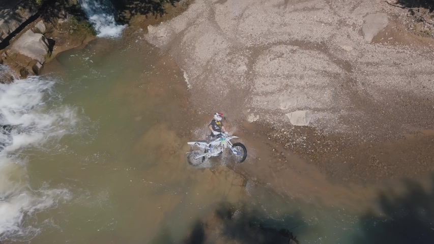 extreme motorcyclist rides near river fall Stock Footage Video (100% ...