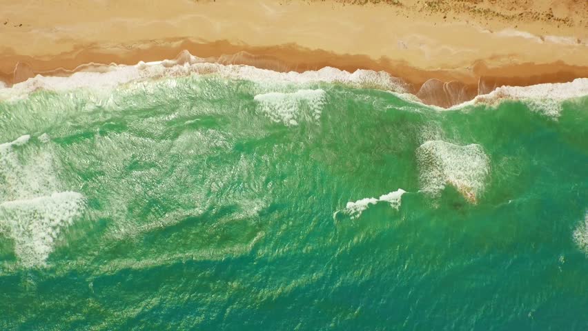 aerial waves covering yellow beach sand Stock Footage Video (100% ...