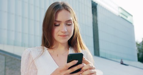 Young Lady Using Mobile Phone Outdoors Stock Footage Video (100% ...
