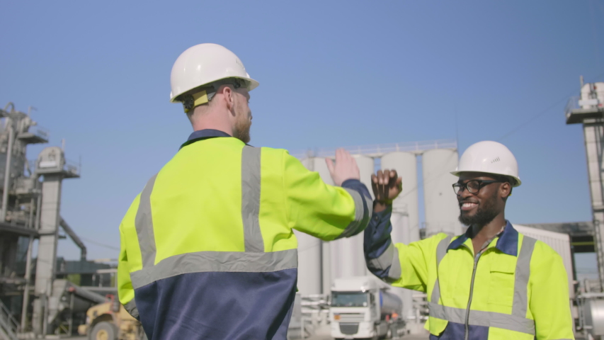 medium shot three electrical workers reviewing Stock Footage Video (100 ...