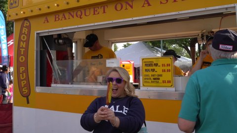Woman eating corn dog Stock Video Footage - 4K and HD Video Clips ...