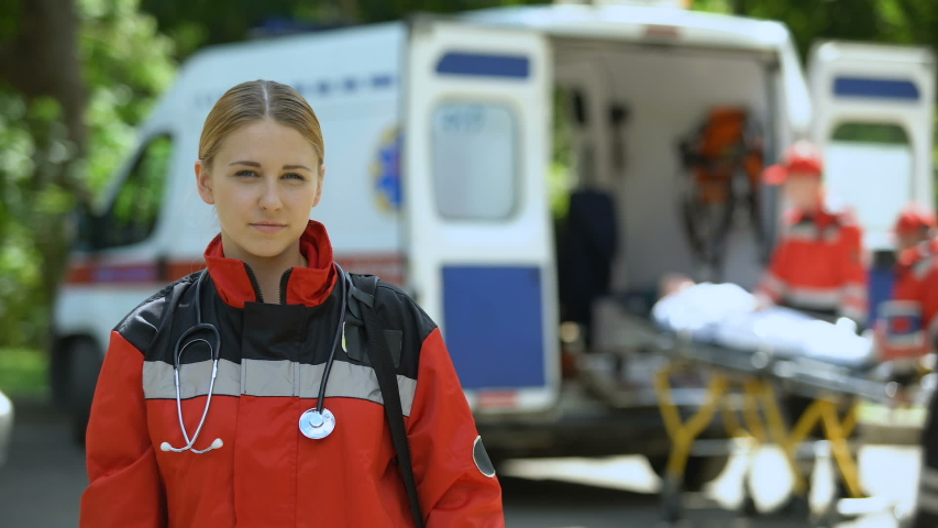 paramedic looks camera getting into ambulance Stock Footage Video (100% ...