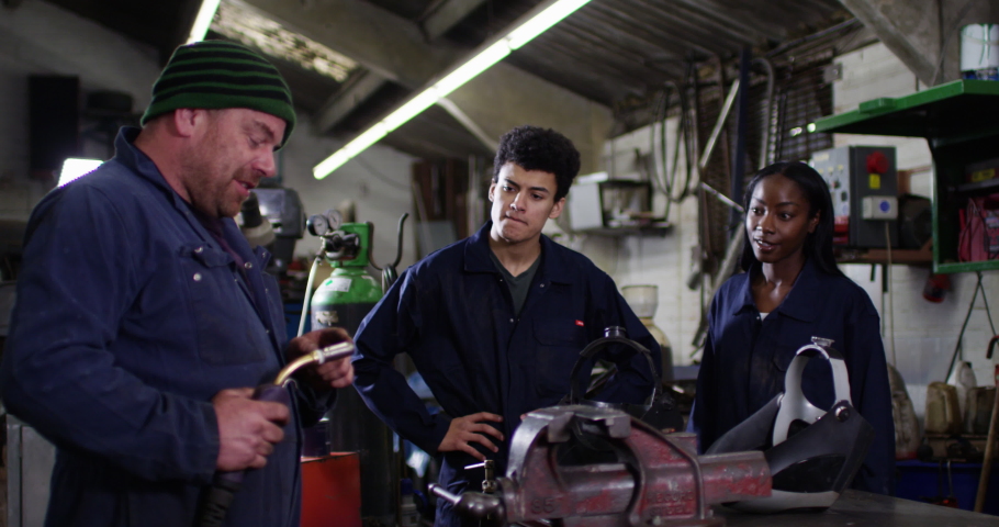4k young apprentices learning experienced mechanic Stock Footage Video ...