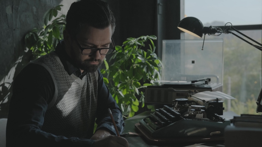 In the office working man concentrated typing some notes on the ...