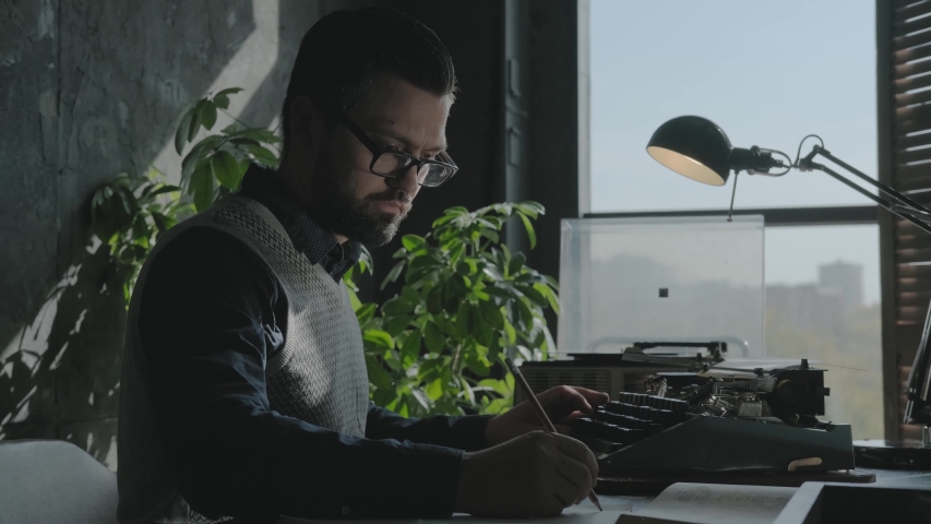 In the office working man concentrated typing some notes on the ...