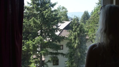Woman Unveiling Window Curtains Watching Trees Stock Footage Video (100 ...
