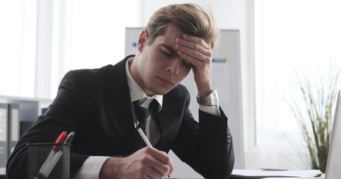 Businessman Suffering Headache While Writing Notes Stock Footage Video ...