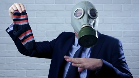 Businessman Gas Mask Holding Stinky Sock Stock Footage Video (100% ...