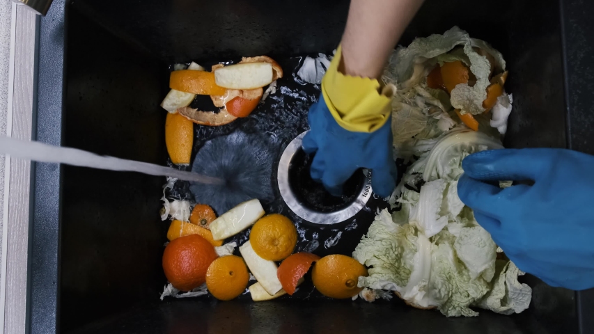 using kitchen disposer grind food waste Stock Footage Video (100% ...