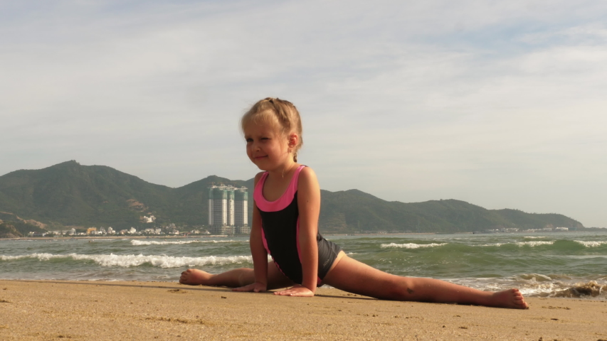 girl does gymnastics on seashore Stock Footage Video (100% Royalty-free ...