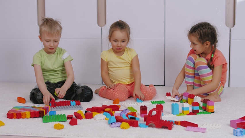 children sitting on carpet playroom playing Stock Footage Video (100% ...