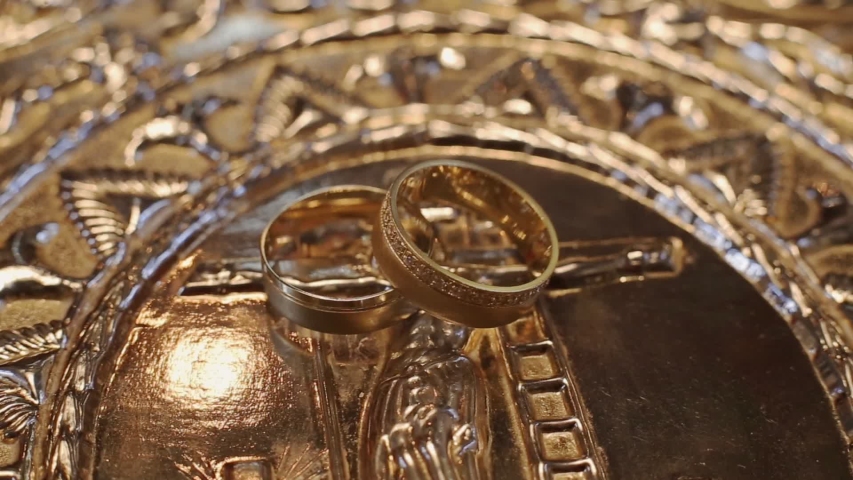 Church crowns and gold wedding rings on the throne during a church ...