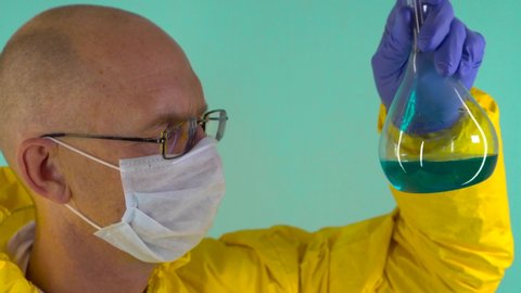 Adult Bald Scientist Evaluates Blue Chemical Stock Footage Video (100% ...