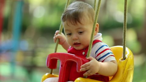 Contemplative Baby Boy Playground Park Swing Stock Footage Video (100% ...