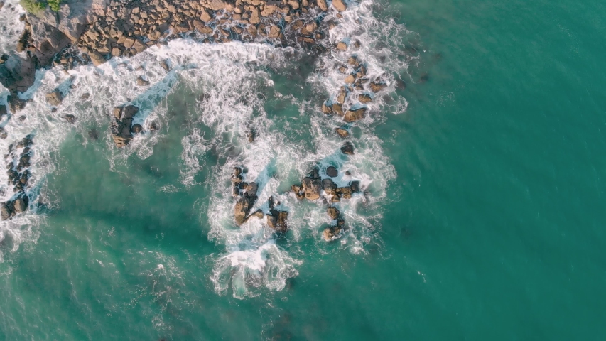 Waves washing over rocks on the shoreline image - Free stock photo ...