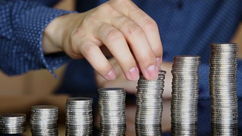 Man Stacking Gold Coins Into Increasing Stock Footage Video (100% ...