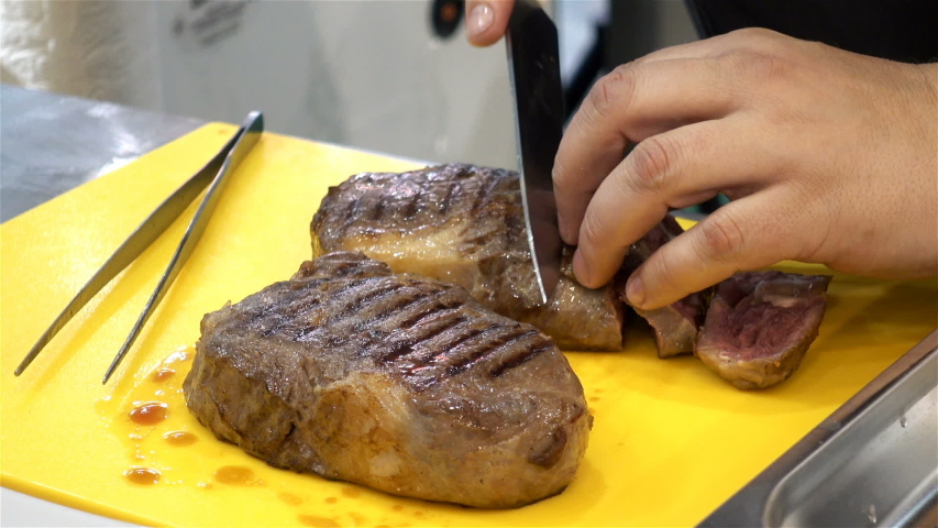 chef's hands cut fried meat into Stock Footage Video (100% Royalty-free ...