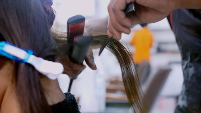 professional male hairdresser straightening his client's Stock Footage ...
