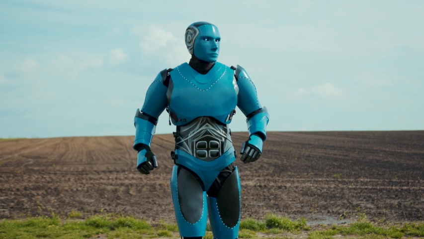 Cyber droid prototype humanoid walking at night near wind station ...