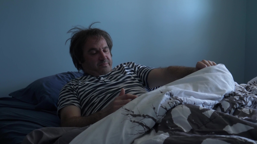 Man waking up in the middle of the night and noticing he has urinated ...