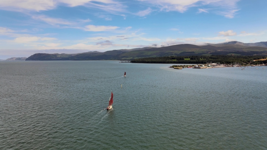 red sailing boats menai strait infront Stock Footage Video (100% ...