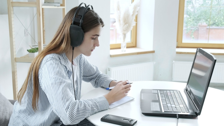 serious girl student wears headphones studies Stock Footage Video (100% ...