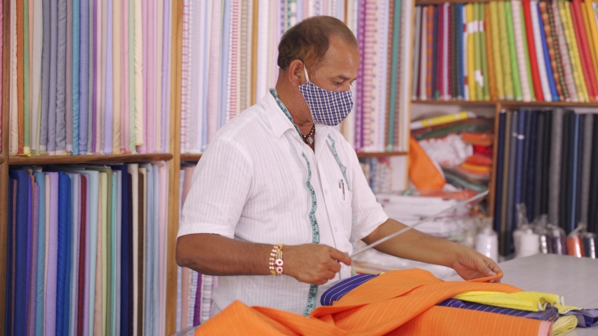 shopkeeper medical mask measuring cloth using Stock Footage Video (100% ...