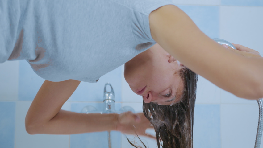 young woman washes away shampoo her Stock Footage Video (100% Royalty ...