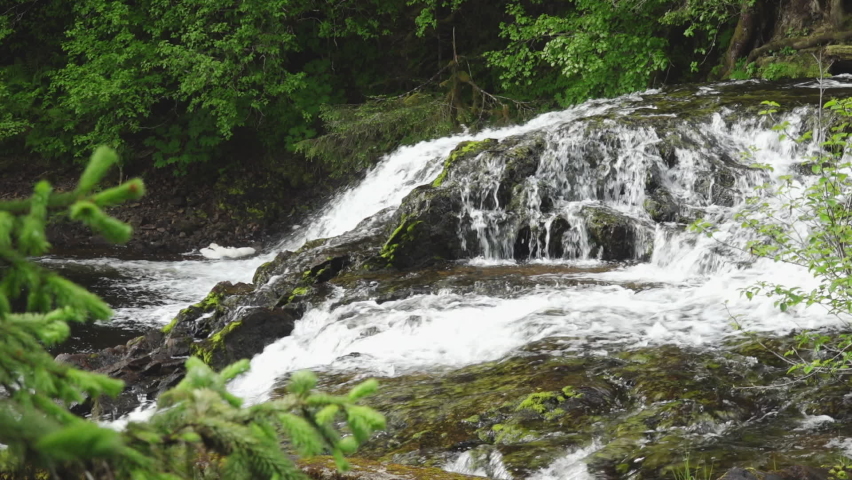 pavlof river rushing over rocks behind Stock Footage Video (100% ...