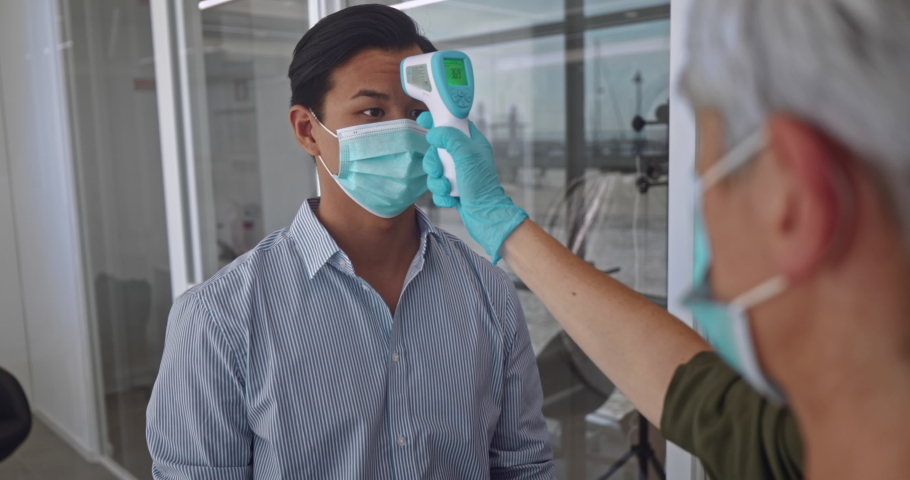 man covid mask checking temperature before Stock Footage Video (100% ...