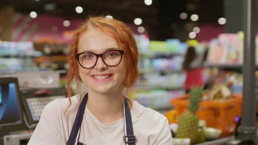 portrait beautiful redhead cashier eyeglasses confidently Stock Footage ...