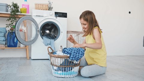 Little Girl Throwing Clothes Fron Laundry Stock Footage Video (100% ...