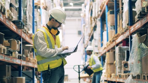 Storeman Uniform Typing On Laptop Among Stock Footage Video (100% ...