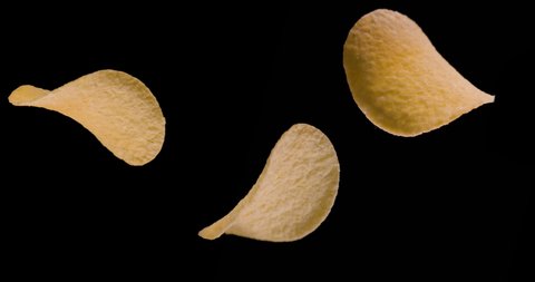 Three Potato Chips Spinning On Black Stock Footage Video (100% Royalty ...