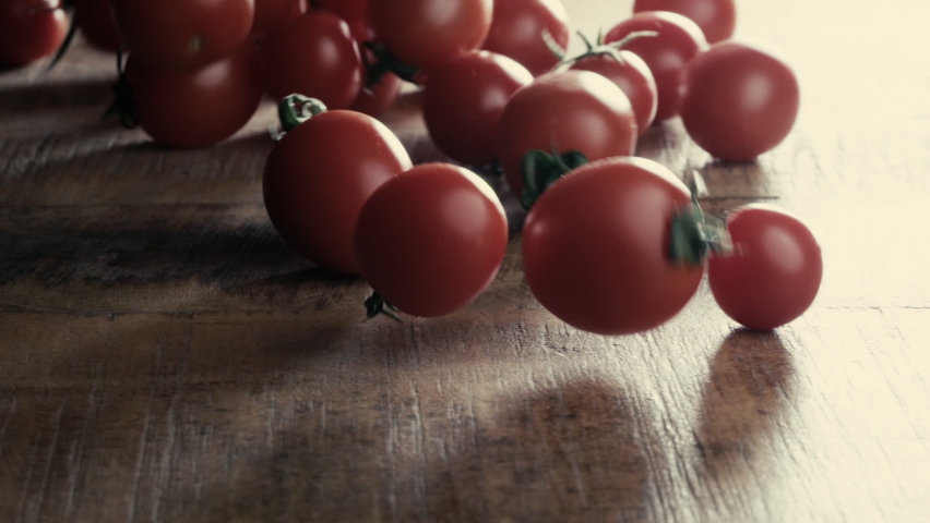 rolling tomatoes on wooden table Stock Footage Video (100% Royalty-free ...