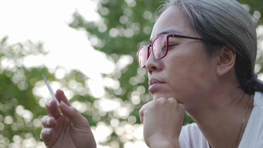 relaxed woman smoking sunny park on Stock Footage Video (100% Royalty ...