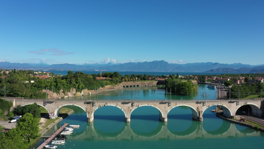 red train passing arch bridge over Stock Footage Video (100% Royalty ...
