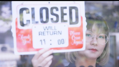 Young Asian Woman Flipping Closed Sign Stock Footage Video (100% ...