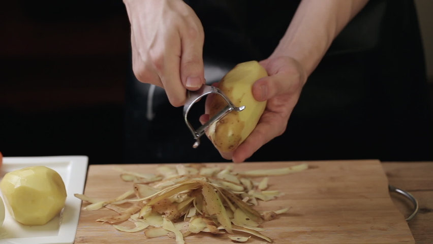 Mans Hand-peeled Potatoes with a Stock Footage Video (100% Royalty-free ...