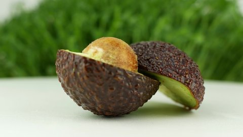 Avocado Rotates On Green Grass Background Stock Footage Video (100% ...