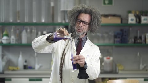 Science Professor Pouring Smokey Liquid Into Stock Footage Video (100% ...