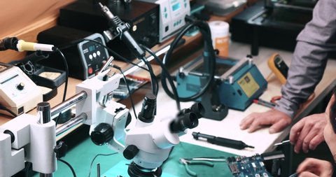 Men Women Repair Motherboard Using Microscope Stock Footage Video (100% ...