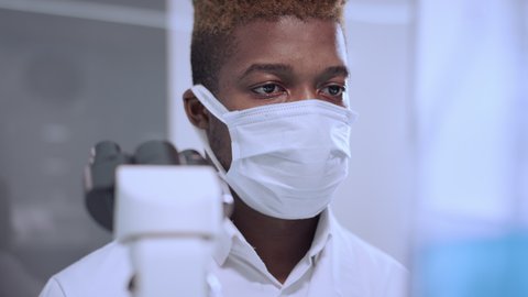 African Ethnicity Doctor Using Microscope Laboratory Stock Footage ...