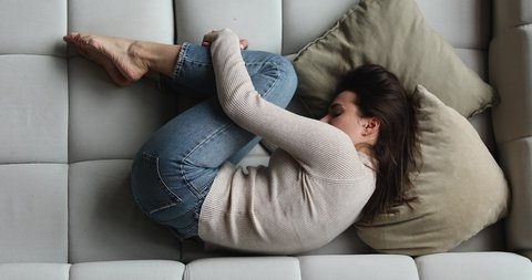 Woman Lying On Couch Curled Suffers Stock Footage Video (100% Royalty ...