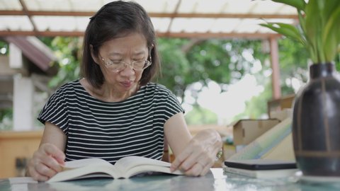 Senior Asian Woman Reading Book Hobby Stock Footage Video (100% Royalty ...