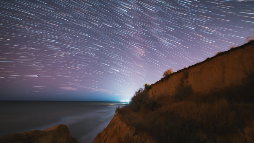 Night starry sky illuminated by the Milky Way and stars over a mountain ...