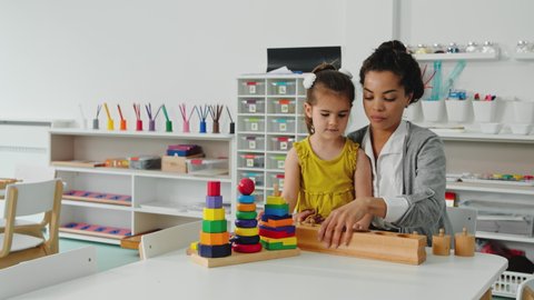 Young Girl Sitting Teachers Lap Playing Stock Footage Video (100% ...