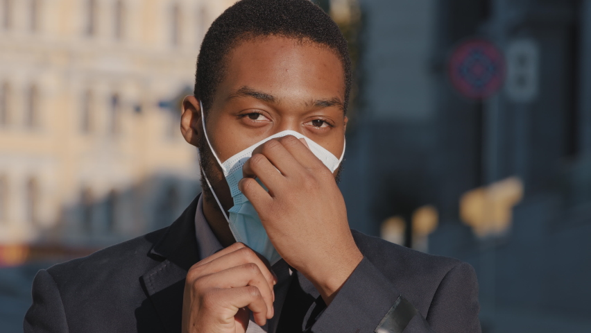 Head shot portrait man in medical mask pose on grey studio wall, taking ...